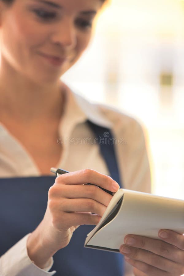 Midsection of Young Waitress Writing on Notepad at Restaurant Stock ...