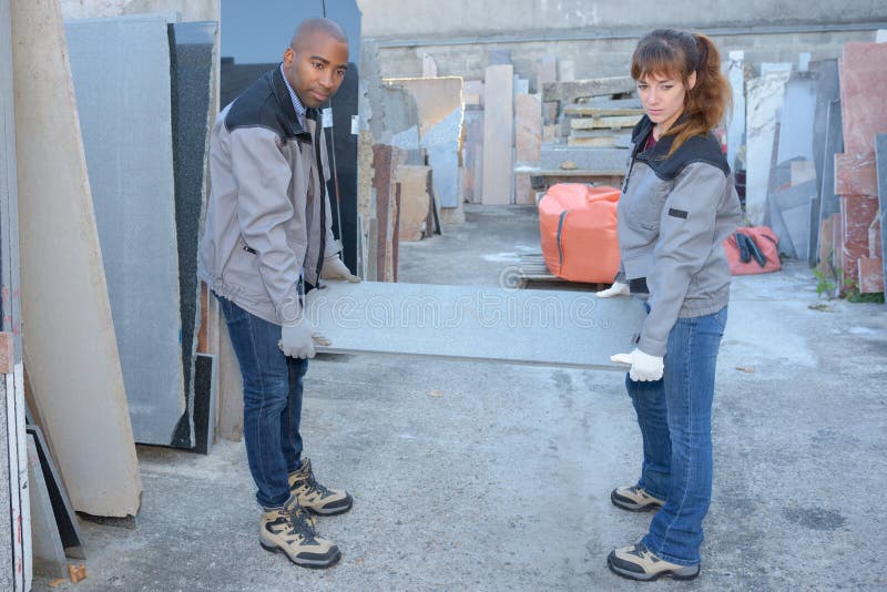 Young Warehouse Workers Holding Metal Plate Stock Image - Image of male ...