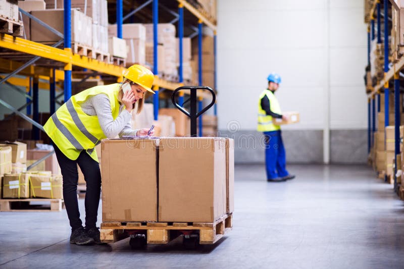 Young Warehouse Workers with Smartphone. Stock Image - Image of call ...