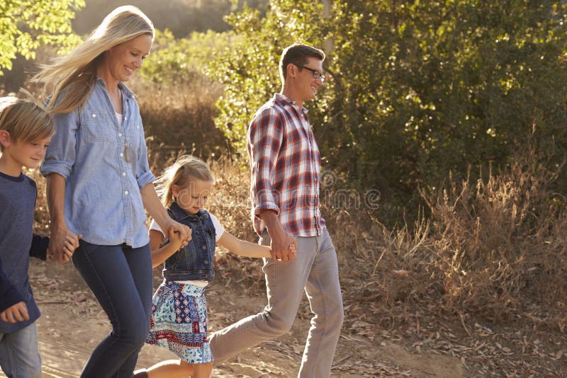 Young White Family Walking on a Path in Sunlight, Side View Stock Image ...