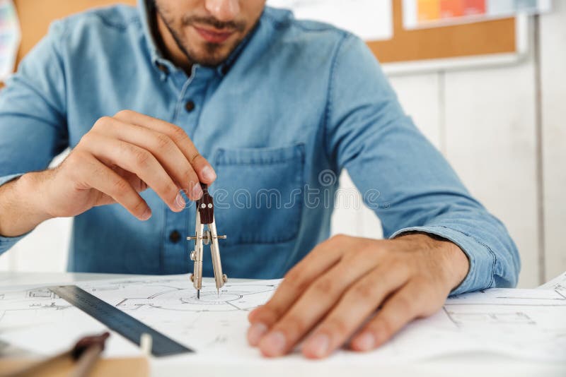 Young White Man Using Compass Working with Drawings in Office Stock ...