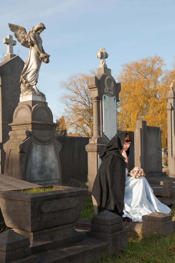 Woman Mourning at Cemetery stock image. Image of graveyard - 2404973