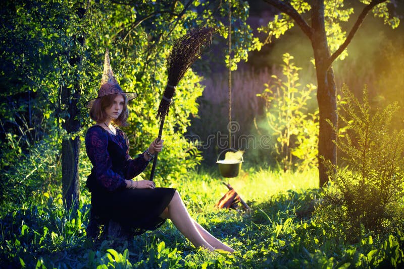 Young Witch by Fire in Magic Forest Makes Magic Potion Stock Photo ...