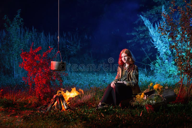 Young Witch by Fire in Night Forest Prepares Magic Potion Stock Photo ...