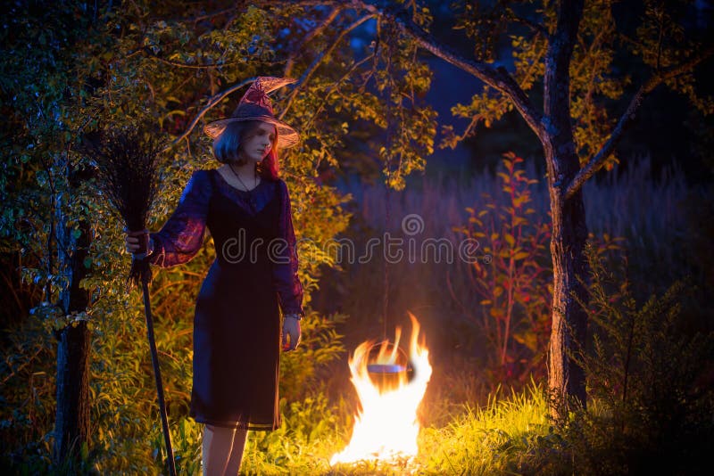 Young Witch by Fire in Night Forest Stock Photo - Image of females ...