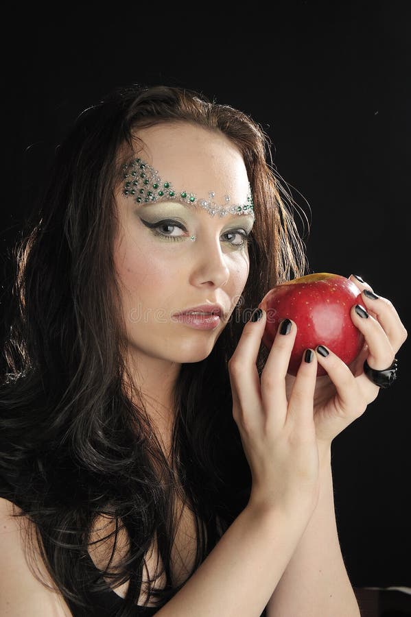 Young witch with red apple stock photo. Image of hold - 8173056