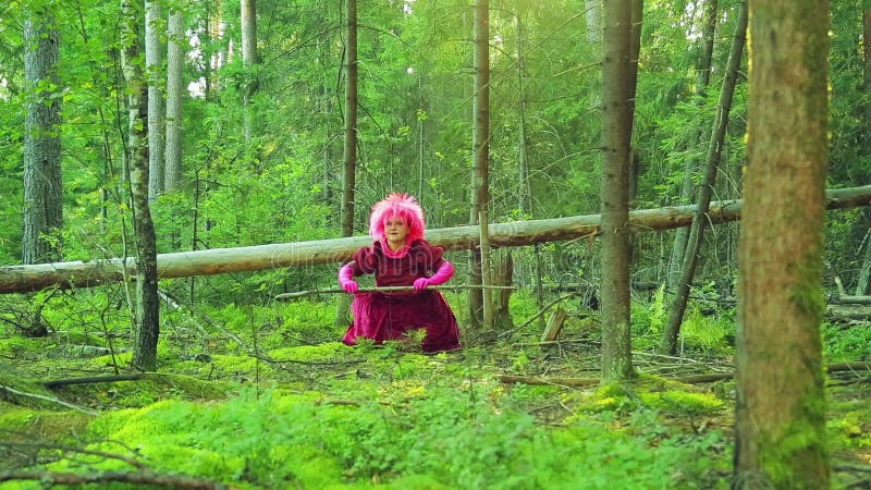 A Young Witch in Red in the Forest is Dancing a Ritual Dance with a ...
