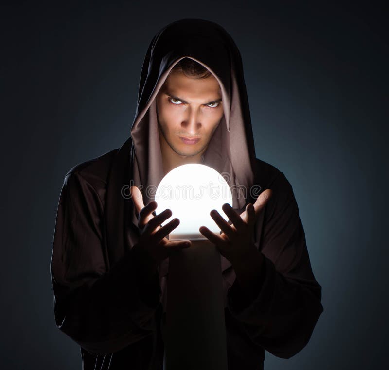 Young Wizard with Crystal Ball in Dark Room Stock Photo - Image of ...