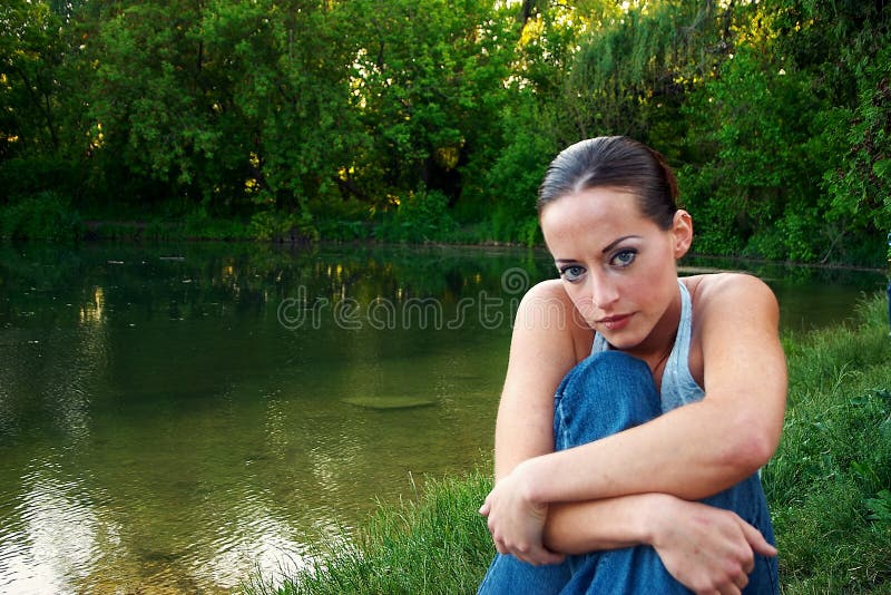Young Woman With Finger In Mouth Sucking Thumb Or Biting Fingernail In