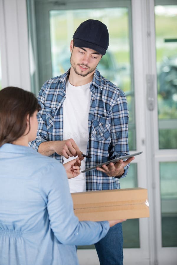 Young Woman Accepting Parcel Box from Delivery Man Stock Photo - Image ...