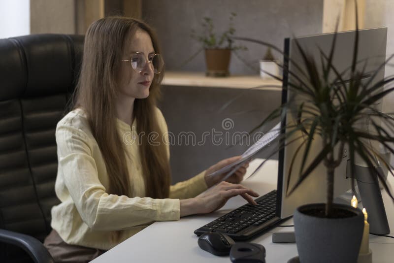 Young Woman Accountant Works at Computer and Holds Documents. Boss is ...