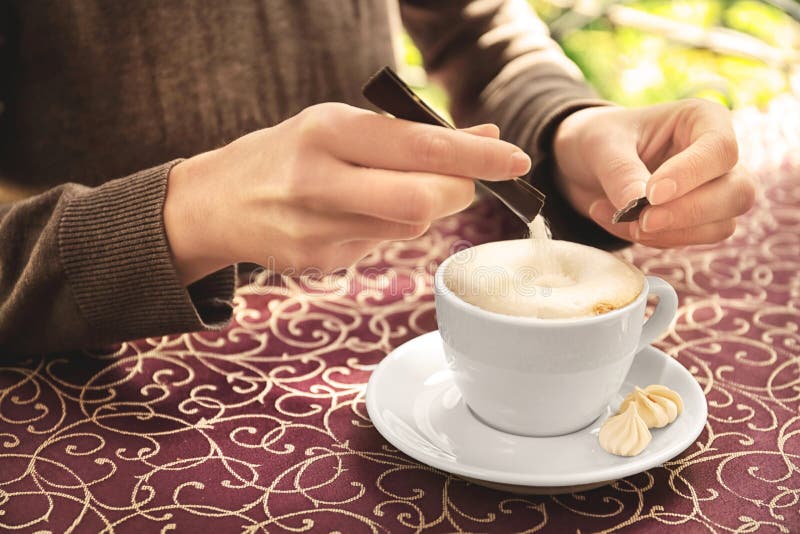 Young Woman Adding Sugar To Delicious Coffee at Table Stock Photo ...
