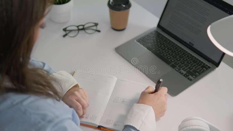 A Young Woman Applies Technology To Study and Work from Home, Using a ...
