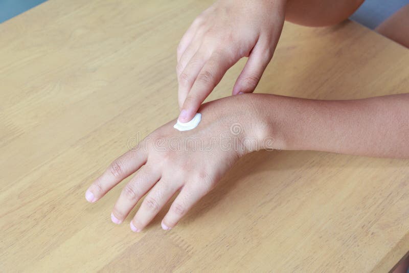 Young Woman Applying Hands Cream Stock Image - Image of girl, clean ...