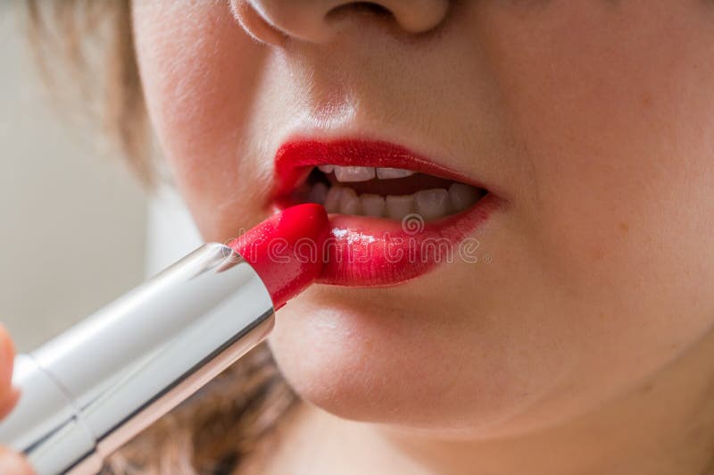 Young Woman is Applying Red Shiny Lipstick Oh Her Lips Stock Image ...
