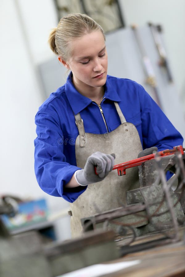 Young Woman Apprentice Learning Ironworks Stock Image - Image of ...