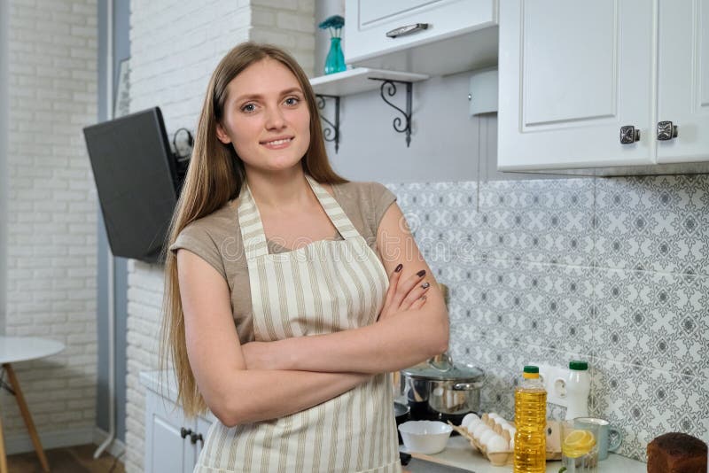 Young Woman in Apron with Folded Crossed Arms, at Home in Kitchen Stock ...