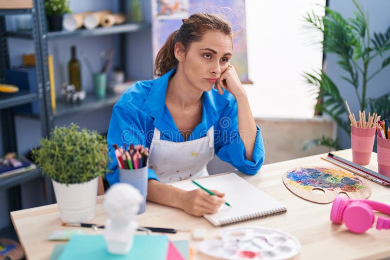 Young Woman Artist Drawing on Notebook with Serious Expression at Art ...