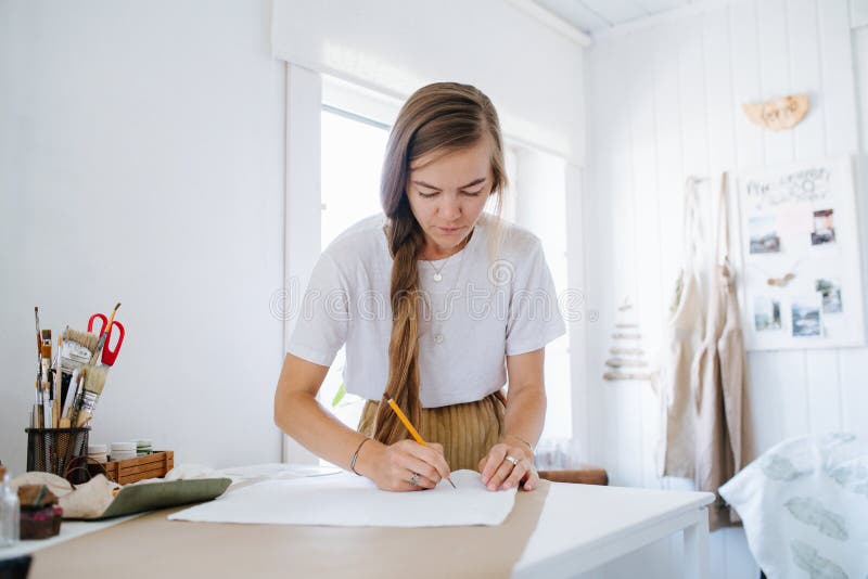 Young Woman Artist Drawing on Sheet, Behind the Table at Home. Stock ...