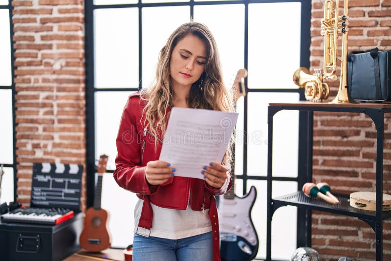 Young Woman Artist Reading Music Sheet at Music Studio Stock Photo ...
