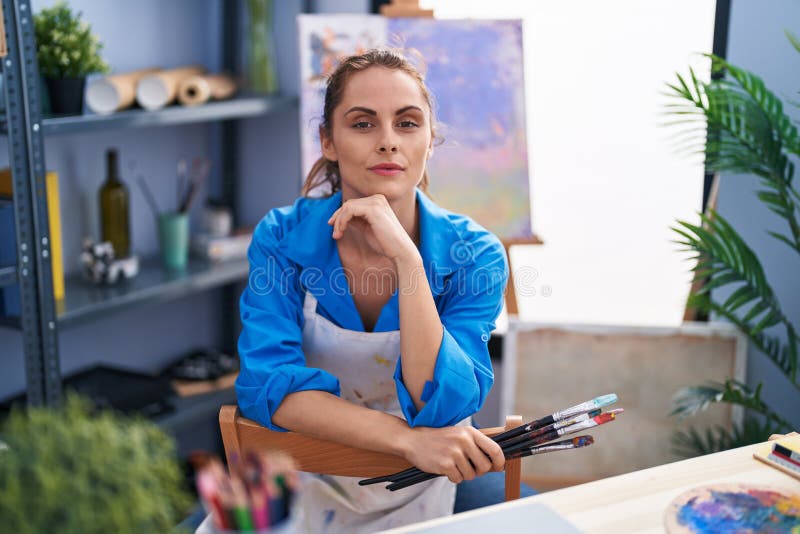 Young Woman Artist Sitting on Chair with Doubt Expression at Art Studio ...