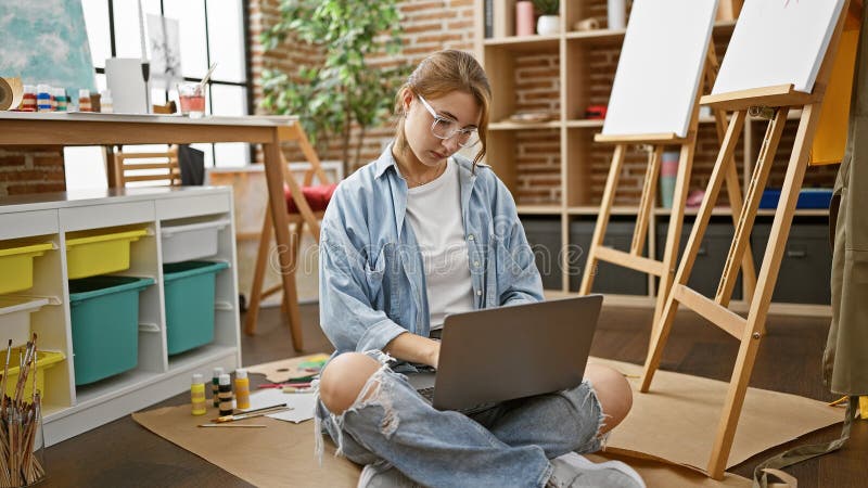 Young Woman Artist Using Laptop Sitting on Floor at Art Studio Stock ...