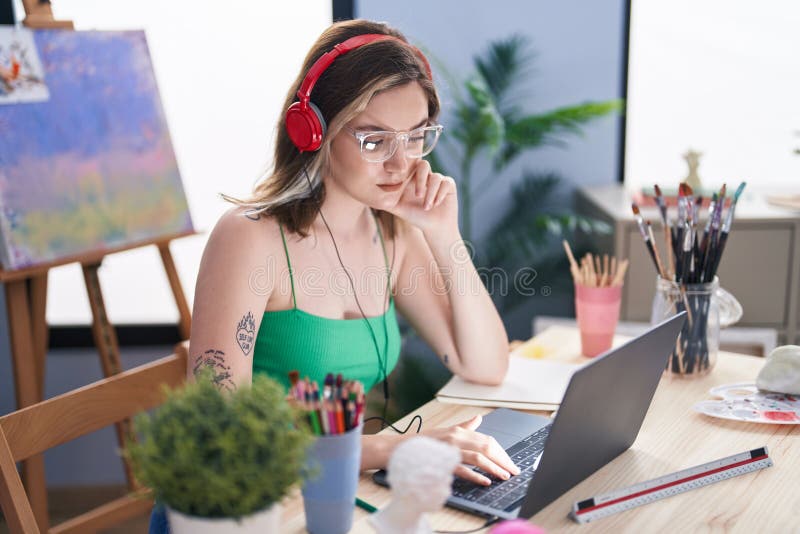Young Woman Artist Using Laptop Sitting on Table at Art Studio Stock ...