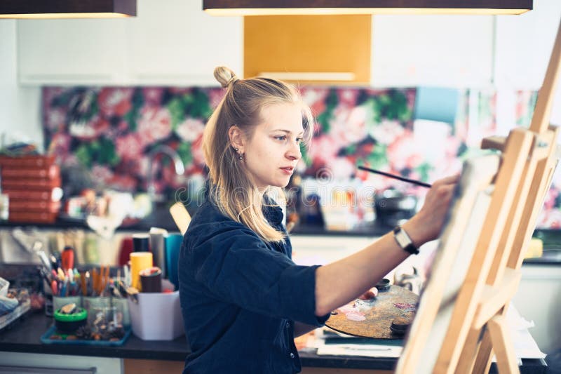 Young Woman Artist Working on Painting in Studio. Selective Focus on ...