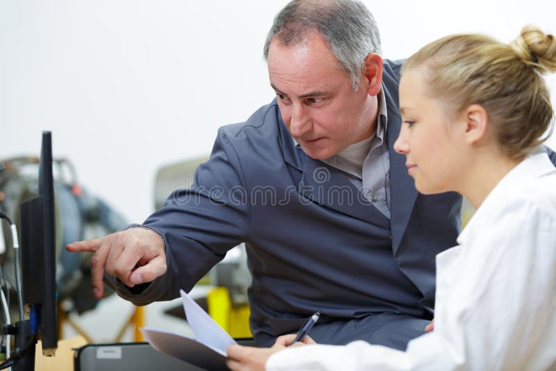 Young Woman As Apprentice Working on Laptop in Office Stock Photo ...