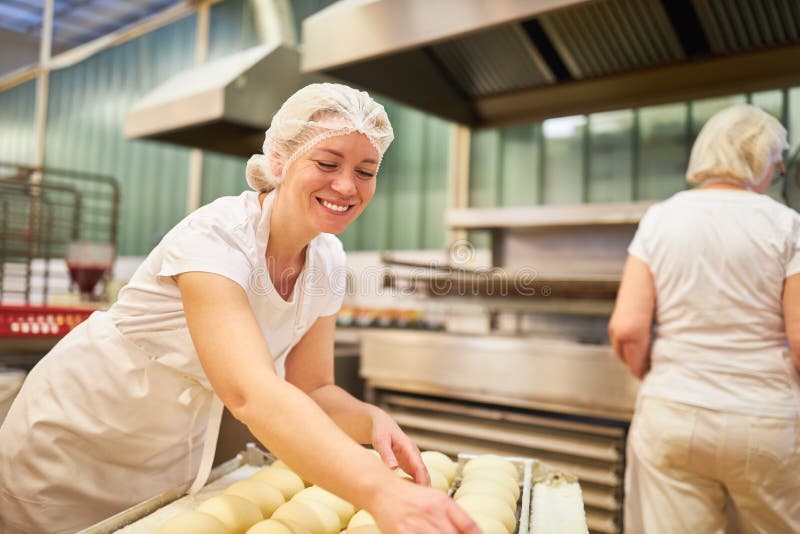 Young Woman As a Baker`s Apprentice Baking Buns Stock Photo - Image of ...