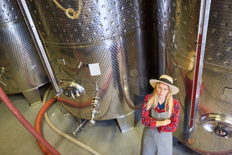 Young Woman As a Winemaker Trainee in Front of a Fermentation Tank ...