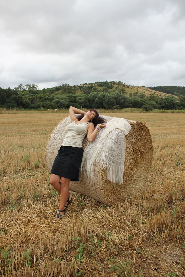 A Young Woman on a Bale of Hay Stock Photo - Image of gorgeous, parasol ...