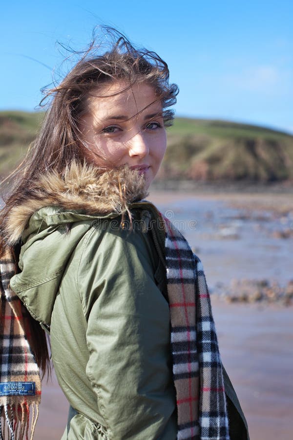 Young Woman at the Beach All Wrapped Up Stock Photo - Image of brunette ...