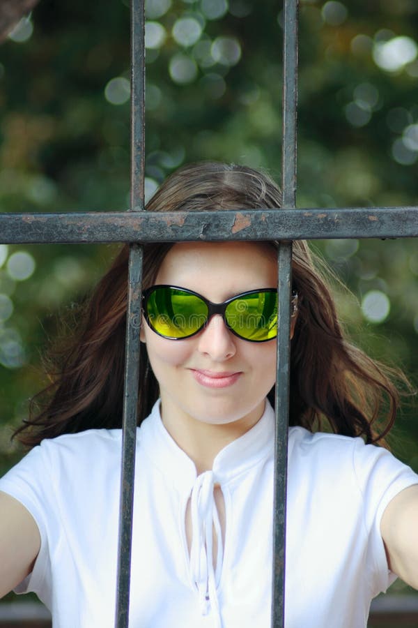 The Young Woman Behind an Iron Protection Stock Photo - Image of ...
