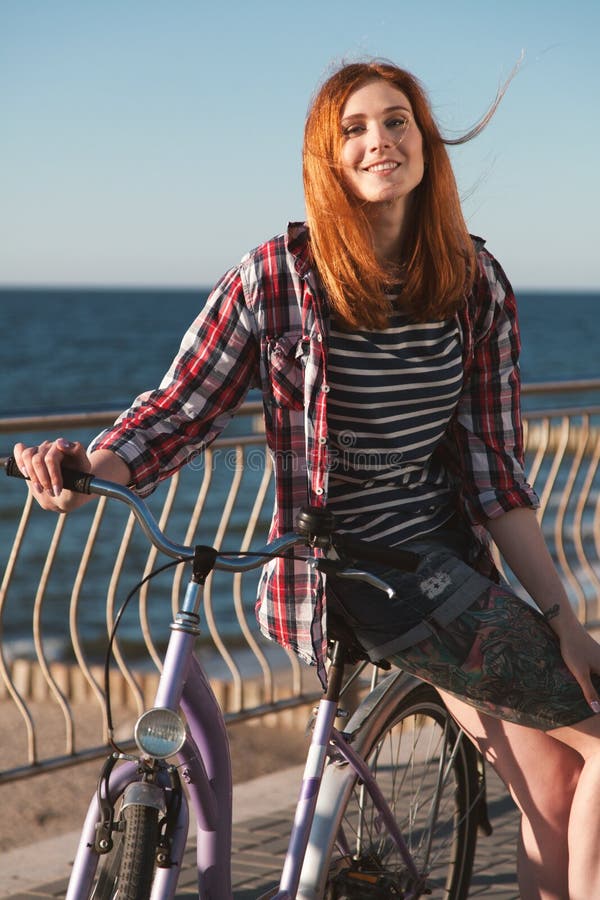 Young woman on a bicycle stock photo. Image of getaway - 93437068