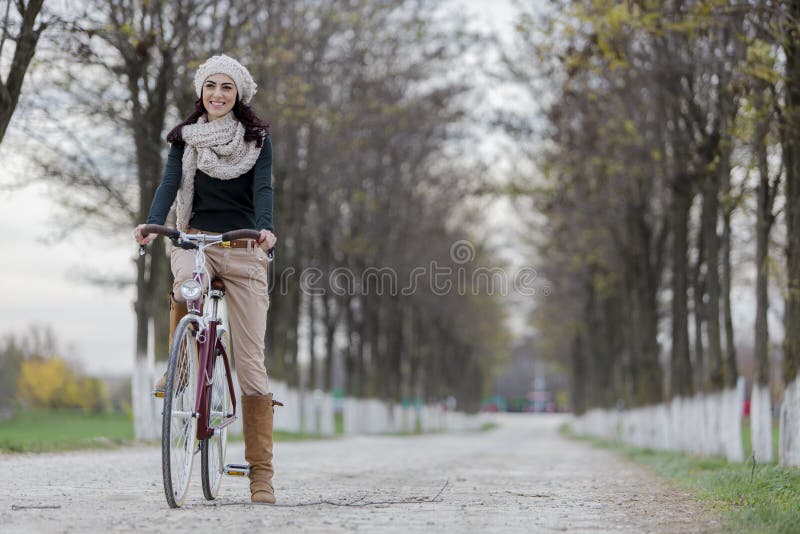 Young woman on the bicycle stock photo. Image of bicycle - 33575446