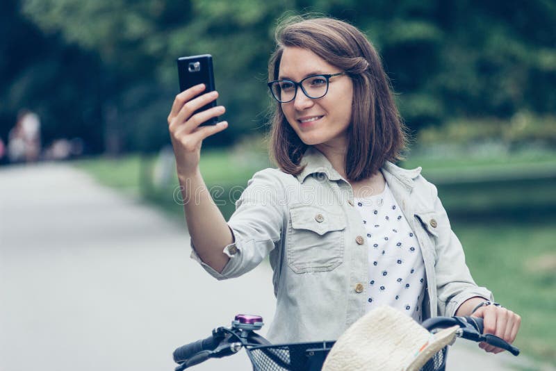 Young Woman On Bicycle Taking Selfie In Park Stock Image Image Of