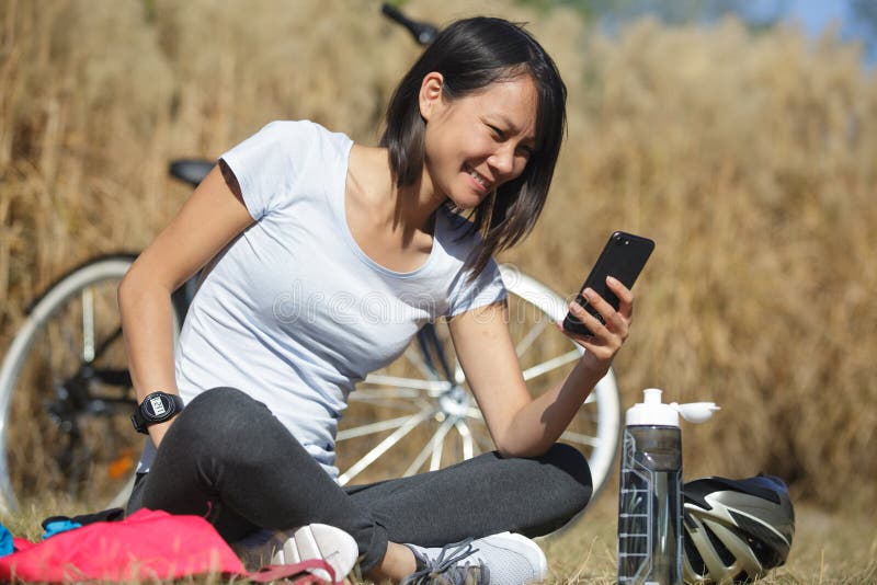 Young Woman on Bike Using Mobile Phone Stock Photo - Image of cheerful ...