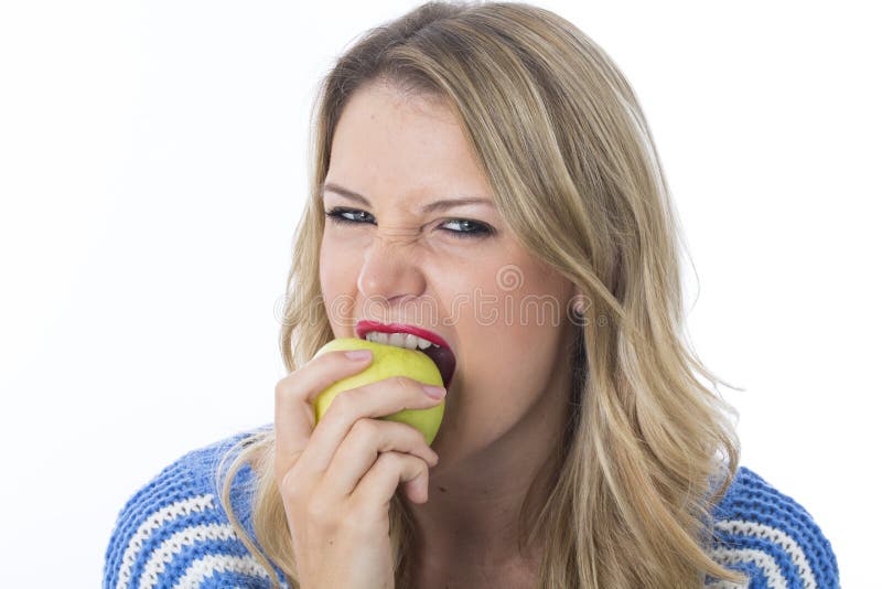 Young Woman Biting into a Green Apple Stock Image - Image of white ...