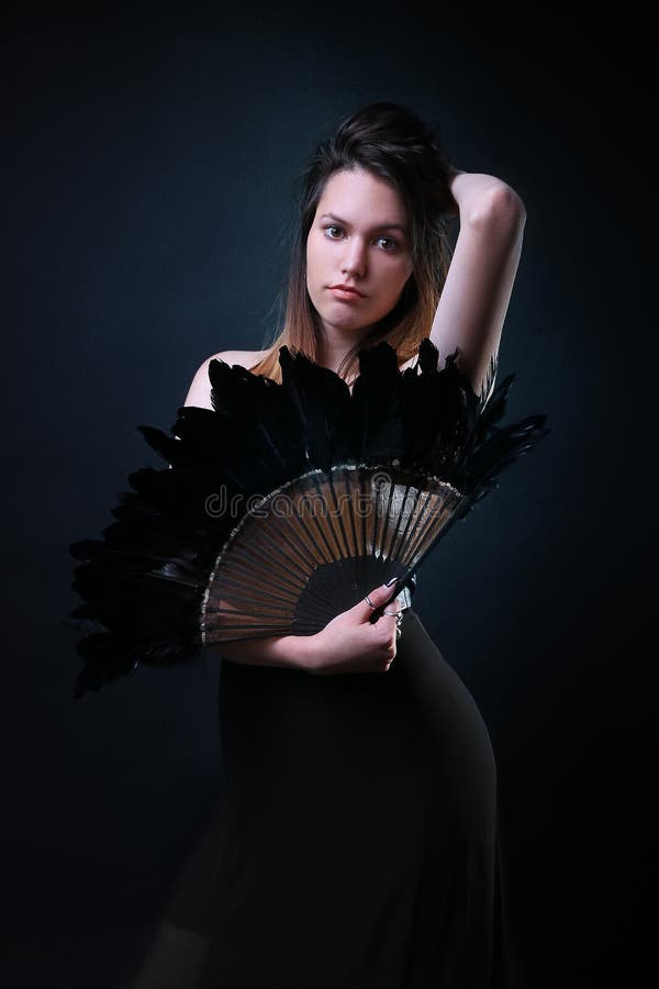 Young Woman with a Black Feather Fan Posing Stock Photo - Image of ...