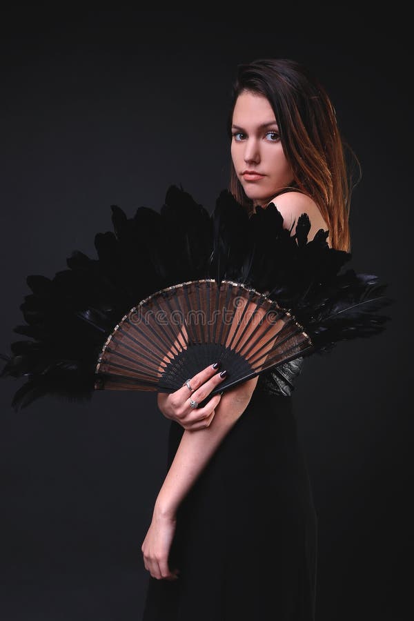 Young Woman with a Black Feather Fan Posing Stock Photo - Image of ...