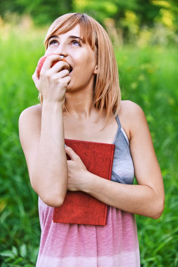 Young Woman with Book Eating Apple Stock Photo - Image of holiday ...