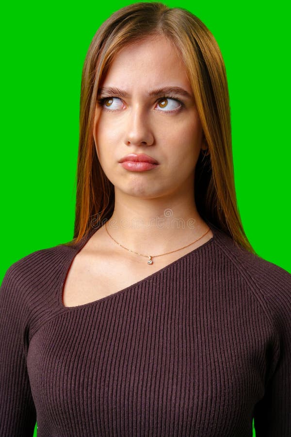 Young Woman With Brown Hair Wearing Brown Sweater Looking Up Stock