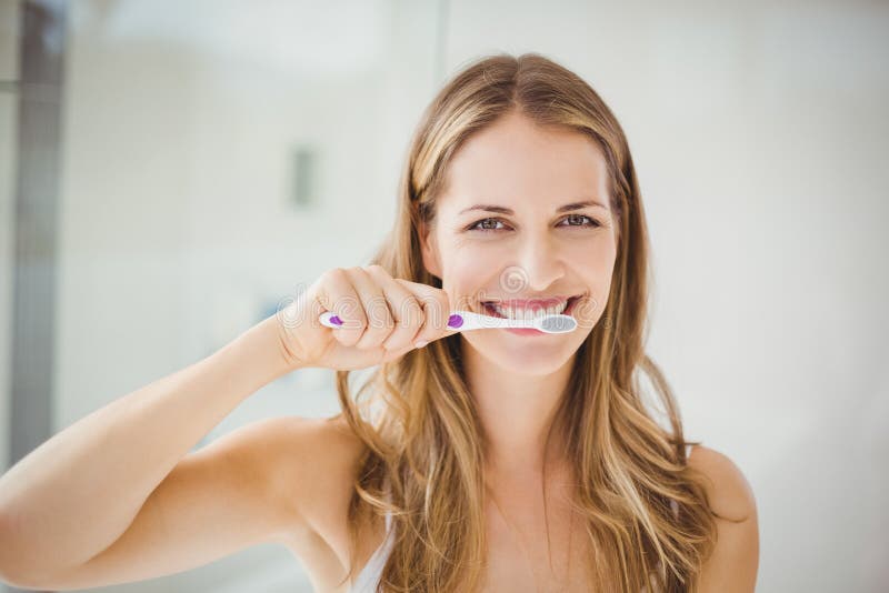 Young woman brushing teeth stock image. Image of brush - 68225315