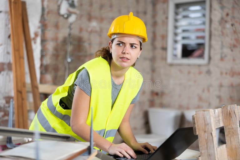 Young Woman Builder Using Laptop in Construction Site Stock Photo ...