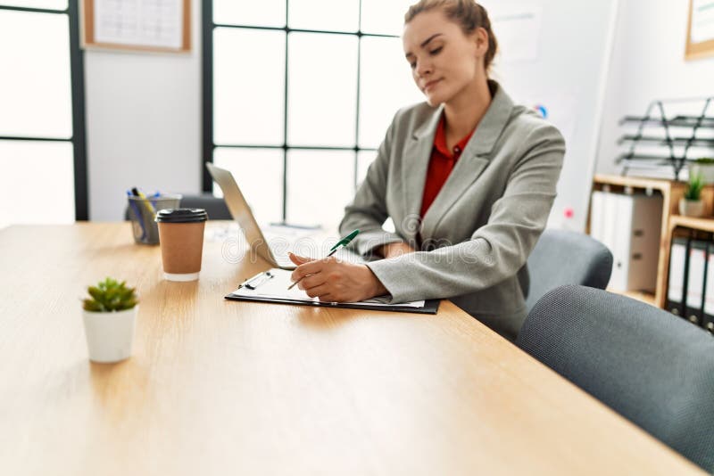 Young Woman Business Worker Writing on Checklist Working at Office ...