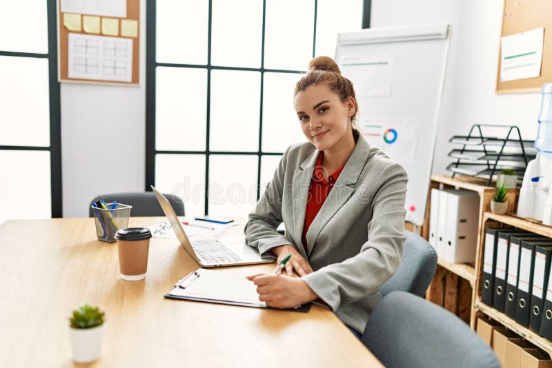 Young Woman Business Worker Writing on Checklist Working at Office ...
