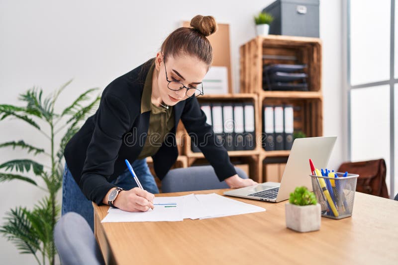 Young Woman Business Worker Writing on Document at Office Stock Photo ...