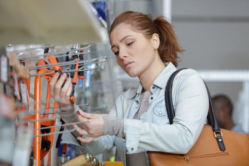 Young Woman Buying Tools in Hardware Store Stock Photo - Image of ...