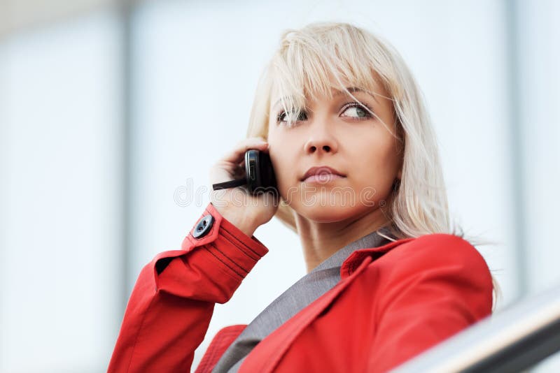 Young Woman Calling on the Phone Against Office Wi Stock Image - Image ...